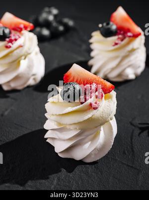 Colorful meringue topped cake on white background Stock Photo - Alamy