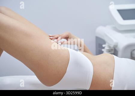 Woman is setting up laser hair removal machine Stock Photo - Alamy