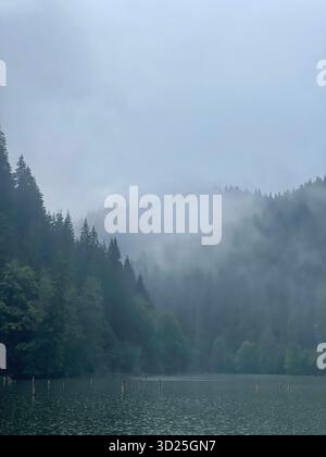 Lake in the mountain on a rainy day seen from a village above it Stock ...