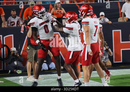 Louisville wide receiver Chris Bell (0) escapes a tackle attempt after ...
