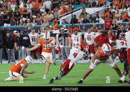 Miami kicker Carter Davis (38) kicks an extra point during the first ...