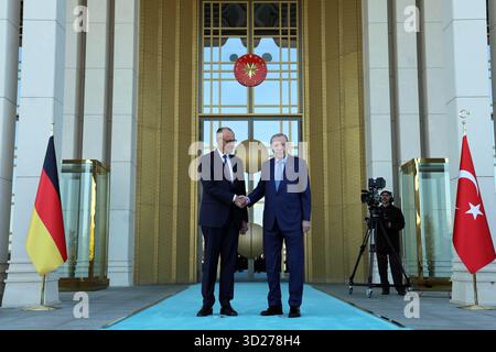 German Chancellor Friedrich Merz (L) shakes hands with Japan's Prime ...