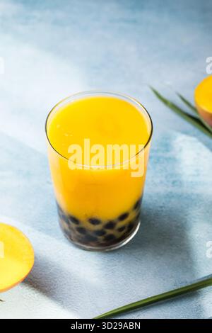 Refreshing mango lassi smoothie with boba pearls, creamy tropical drink ...