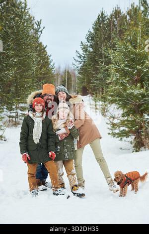 Smile active parents with small son in red checkered sleepwears waiting ...