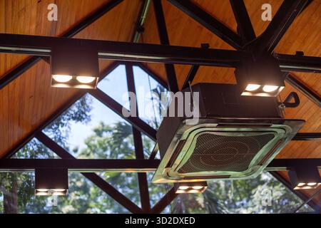 Modern black ceiling-mounted square air conditioner. In a modern cafe ...