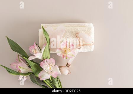 Rose quartz gouache massage scraper and facial massage roller on a ...