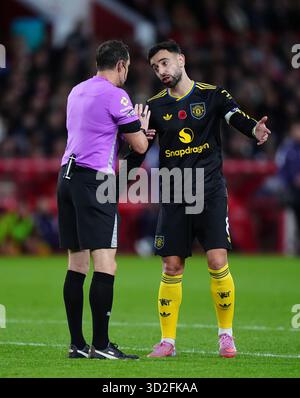 Manchester United's Bruno Fernandes, right, challenges for the ball ...