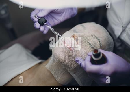 Paraffin Face Mask gauze bandage Therapy Young Woman Receiving Facial ...