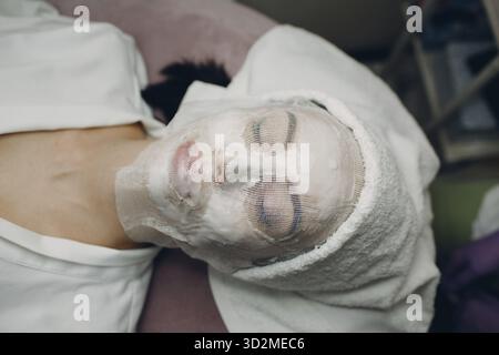 Paraffin Face Mask gauze bandage Therapy Young Woman Receiving Facial ...