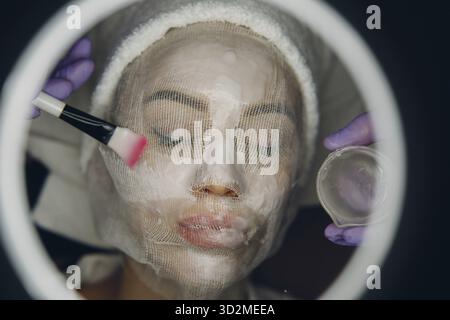 Paraffin Face Mask gauze bandage Therapy Young Woman Receiving Facial ...