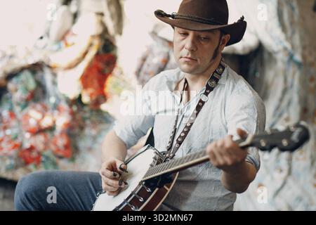 Male musician playing banjo country music sitting chair indoor Stock ...