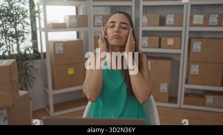 Woman squinting and removing eyeglasses while examining laptop screen ...