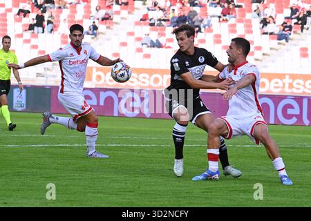 Andrea Meroni of SSC Bari in action against Gennaro Tutino of US ...