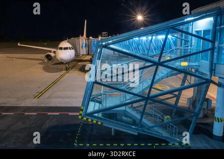 Passenger boarding bridge with stairs at airport gate. Ground ...