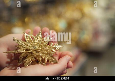 Snowflake with golden sparkles on the Christmas tree with Christmas ...