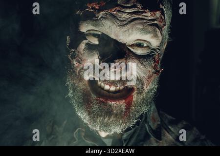 Zombie man portrait in darkness with makeup for halloween party Stock ...