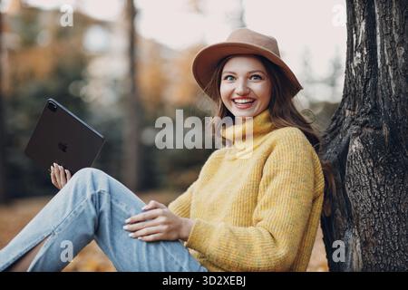 MOSCOW, RUSSIA - OCTOBER 19, 2021: Young woman model sitting with ...