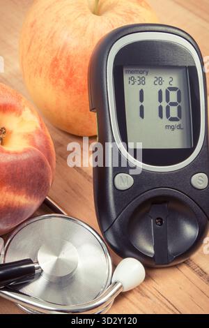 Glucometer with result of sugar level, fresh natural fruits and medical ...