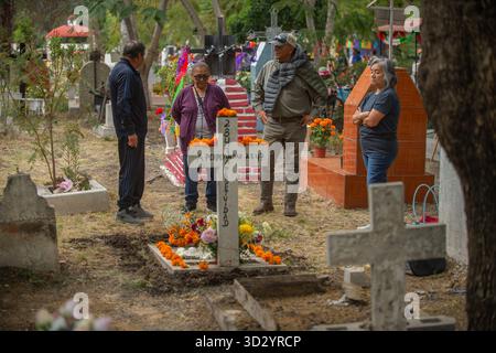 Persons attend the Municipal Cemetery to keep vigil and decorate the ...