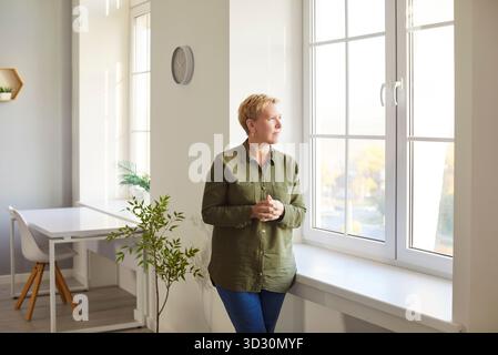 Pensive elegant mature woman enjoying summer evening in Mediterranean ...