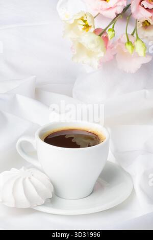 Home composition with a cup of coffee, flowers and a knitted element ...