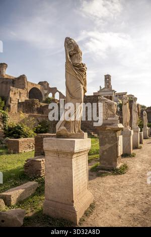 View of weathered, ancient stone statues and carvings resting under a ...