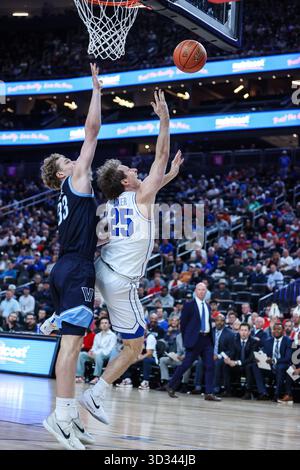 BYU guard Dawson Baker (25) drives as UConn forward Alex Karaban (11 ...