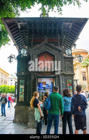People stand in queue to cast their votes at a polling center during ...