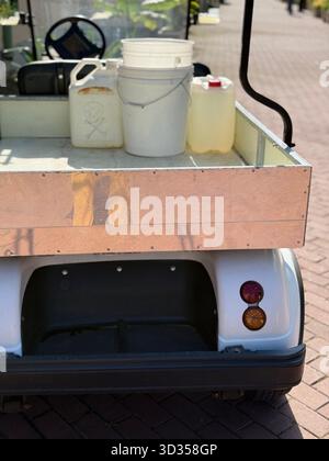 Outdoor cleaning equipment and storage container near stone wall in ...