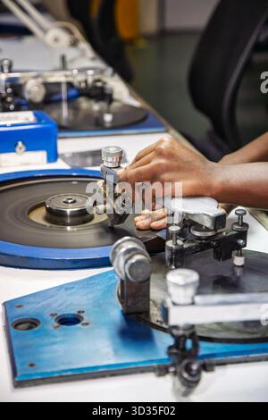 diamond polisher at work, using a polishing wheel to shape and refine a ...
