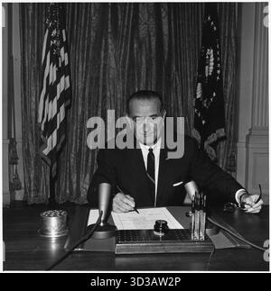 President Lyndon B. Johnson signs the 1964 Civil Rights Act as Martin ...