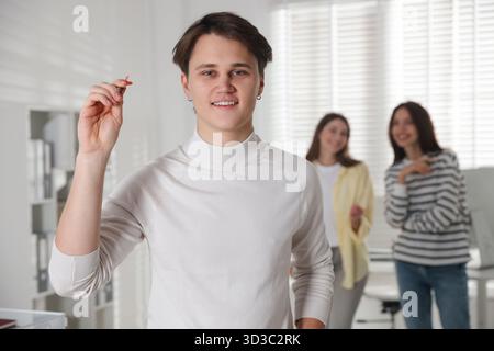 Man playing darts and his colleagues in office Stock Photo - Alamy