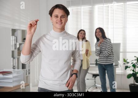 Man playing darts and his colleagues in office Stock Photo - Alamy