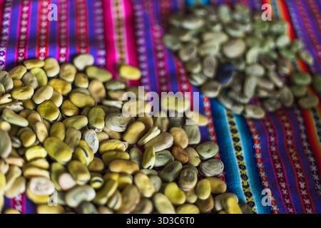 Variety of native Andean crops over traditional Peruvian textile at a ...