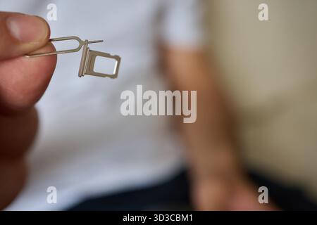 Guide on how to properly insert a SIM card into a smartphone using a ...