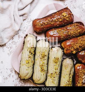 Traditional french eclairs with chocolate. Breakfast in the cafe ...