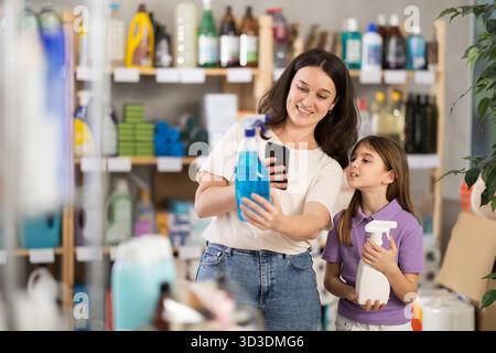 Mom and daughter scanning the barcode on the spray package Stock Photo ...