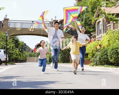 Happy family of four flying kites outdoors high quality photo Stock ...