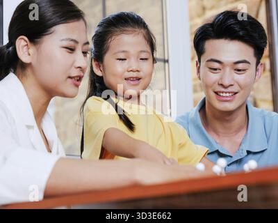 Happy family of three doing molecular structure model together high ...