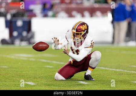 Washington Commanders kicker Matt Gay (16) kicks the ball during an NFL ...