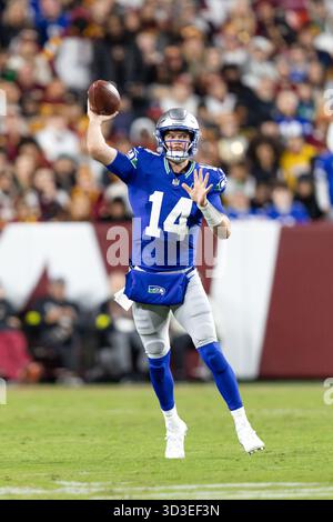 Seattle Seahawks quarterback Sam Darnold (14) rolls out of the pocket ...