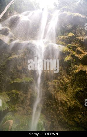 An unusual tropical waterfall. Thin streams of water flow down the ...