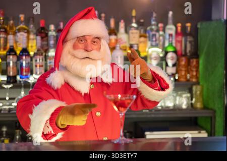 Santa Claus works at the bar making cocktails in a shaker Stock Photo ...