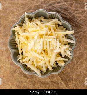 Shredded yellow cheese in the bowl for cooking Stock Photo - Alamy