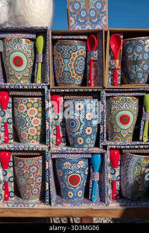 Bright red Moroccan flag with green star on a clear blue sky background ...