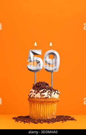 Birthday card with number 59 candle - Cupcake on a green background ...