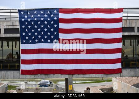 Nov 9, 2025: A large American flag is unfurled over the field before ...