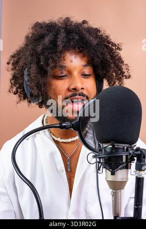 Content black man recording podcast in studio Stock Photo - Alamy
