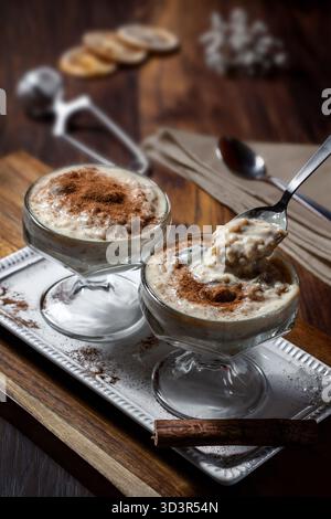 Rice pudding sprinkled with cinnamon, served on a plate Stock Photo - Alamy