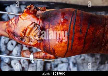 Whole young piglet on spit skewer. Naplavka street food festival Stock ...
